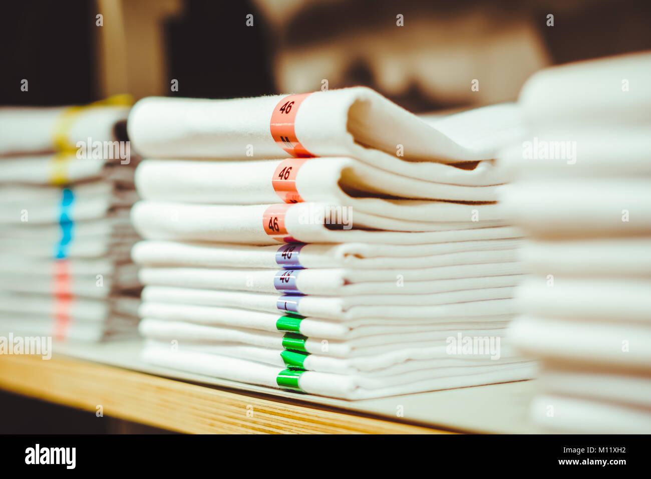 sale shopping background. clothes on shelves in store Stock Photo - Alamy