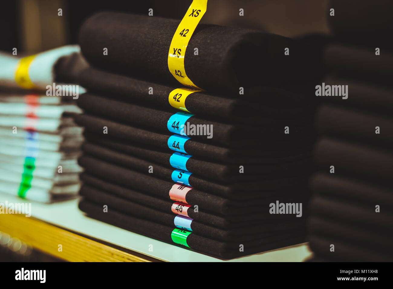 sale shopping background. clothes on shelves in store Stock Photo - Alamy