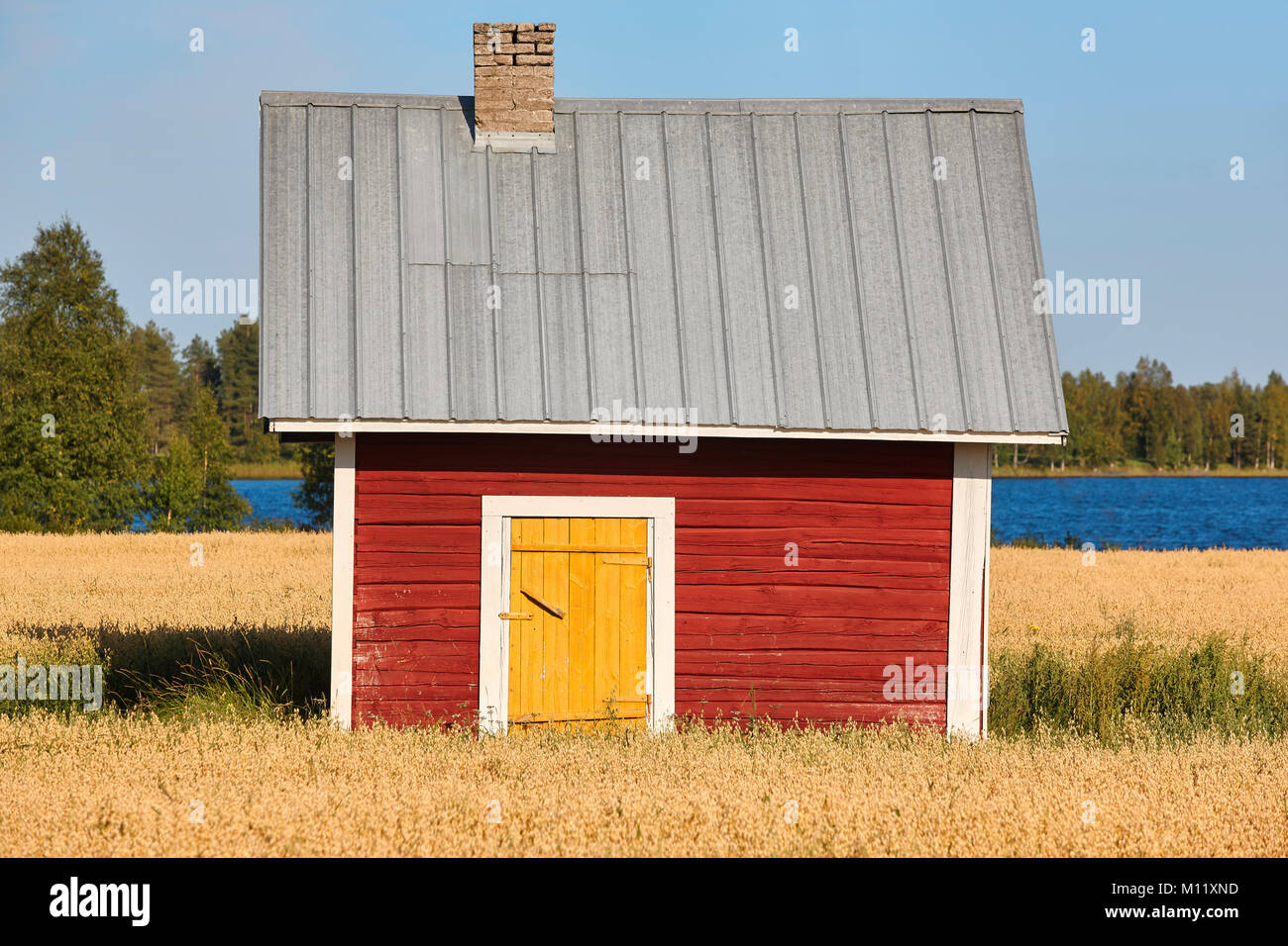 Traditional finnish red wooden farm in the countryside. Finland Stock ...