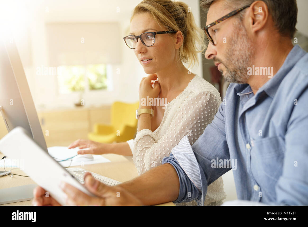 Business people working together on desktop computer Stock Photo - Alamy