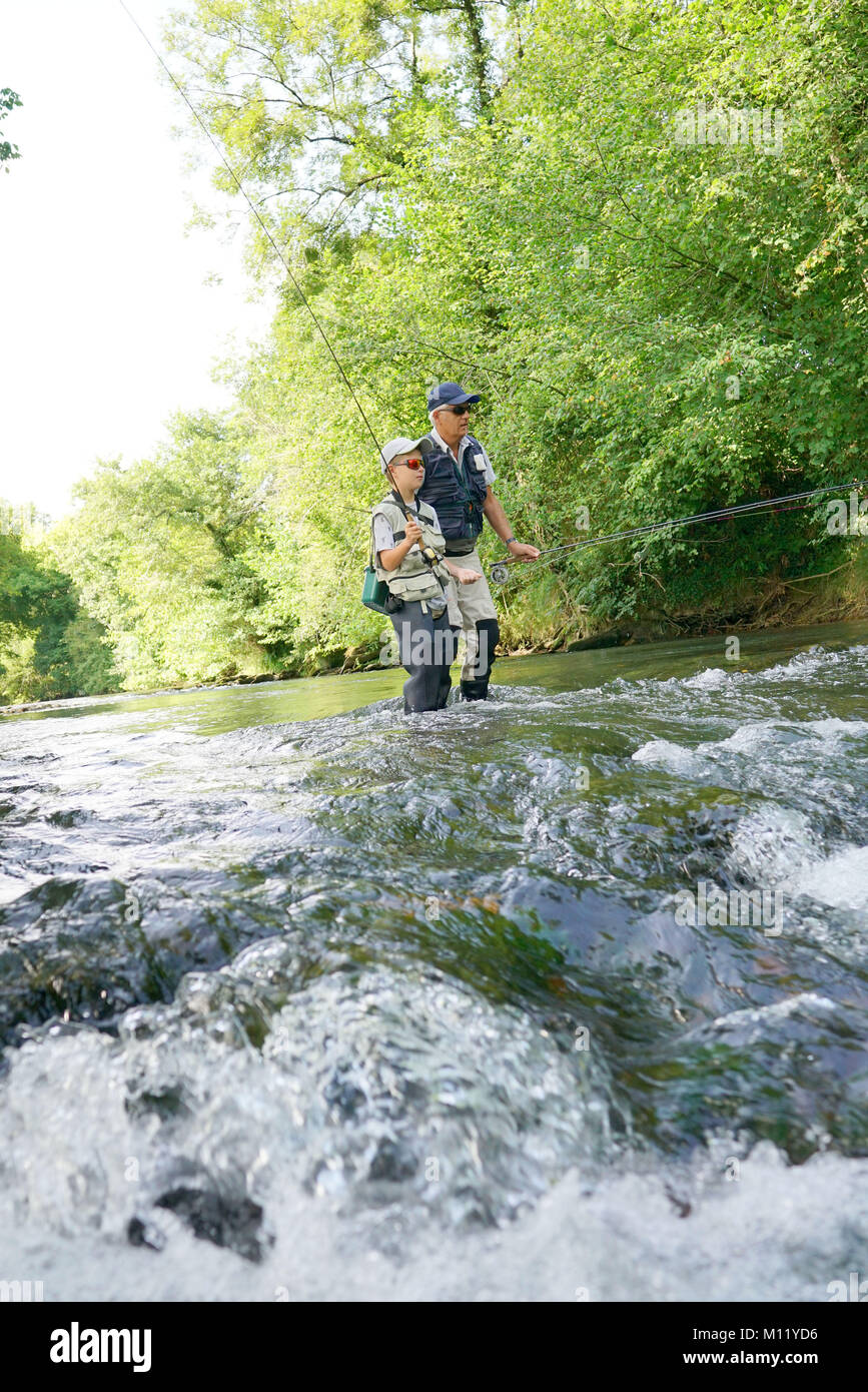 Father and son fly-fishing in river Stock Photo - Alamy