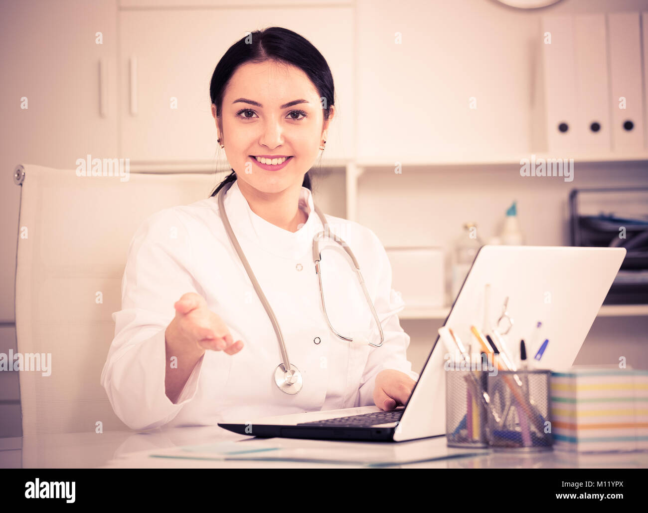 Female doctor having a productive day helping in her office Stock Photo ...