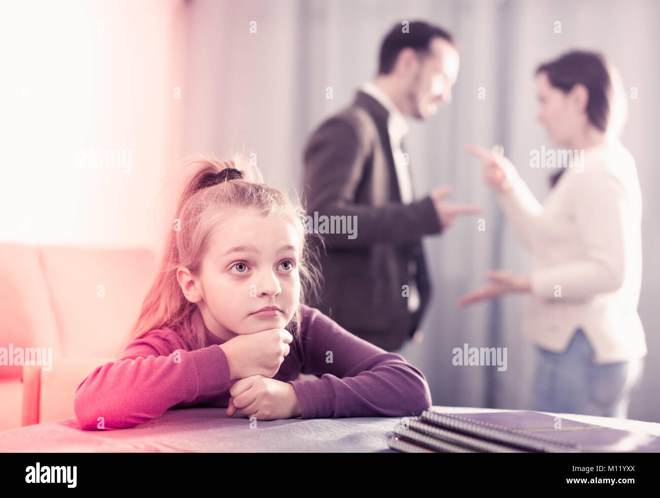 Mom And Dad Arguing With Each Other While Their Daughter At Home Stock