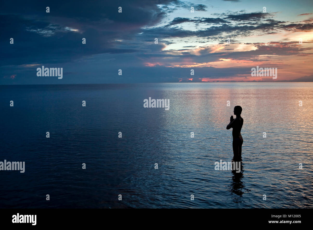 Indonesia, Bali island, Tejakula, Gaia Oasis beach. Woman greeting the ...