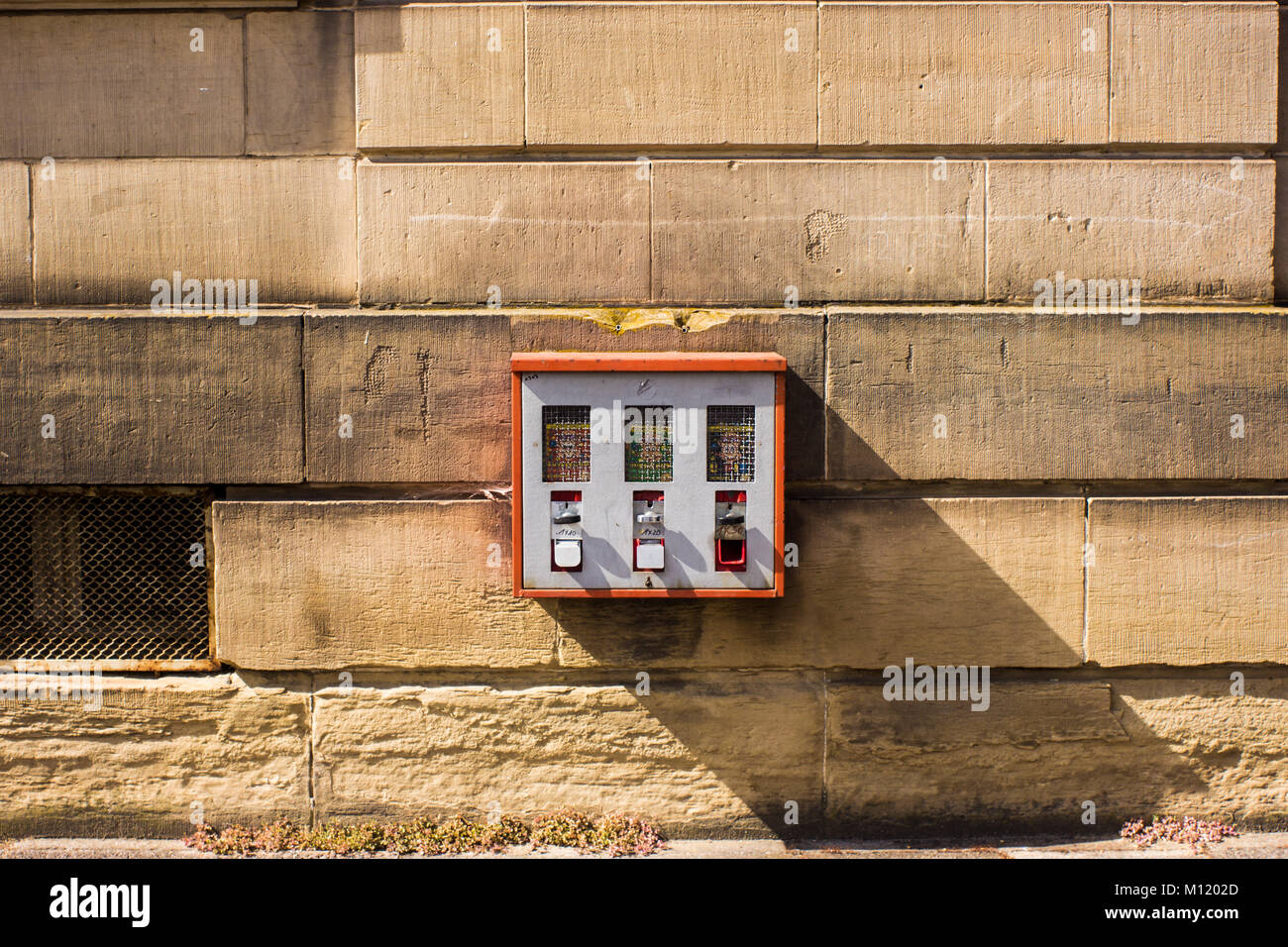 Vintage chewing gum vending machine on a wall Stock Photo - Alamy