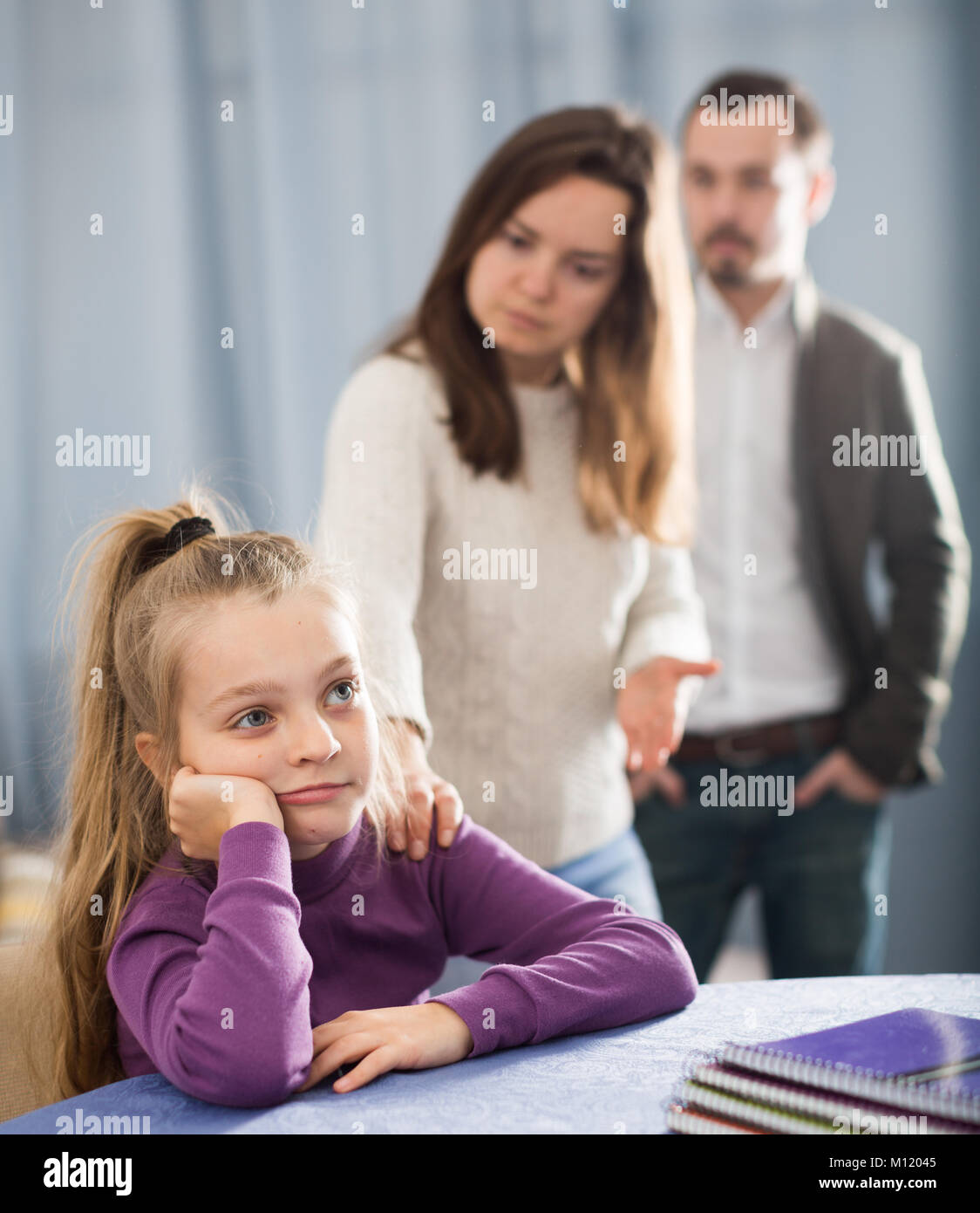 Father and mother telling off their daughter for disobedience Stock ...