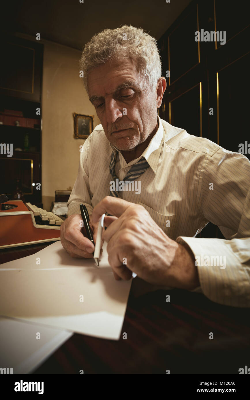 Man sitting desk pencil paper hi-res stock photography and images - Alamy