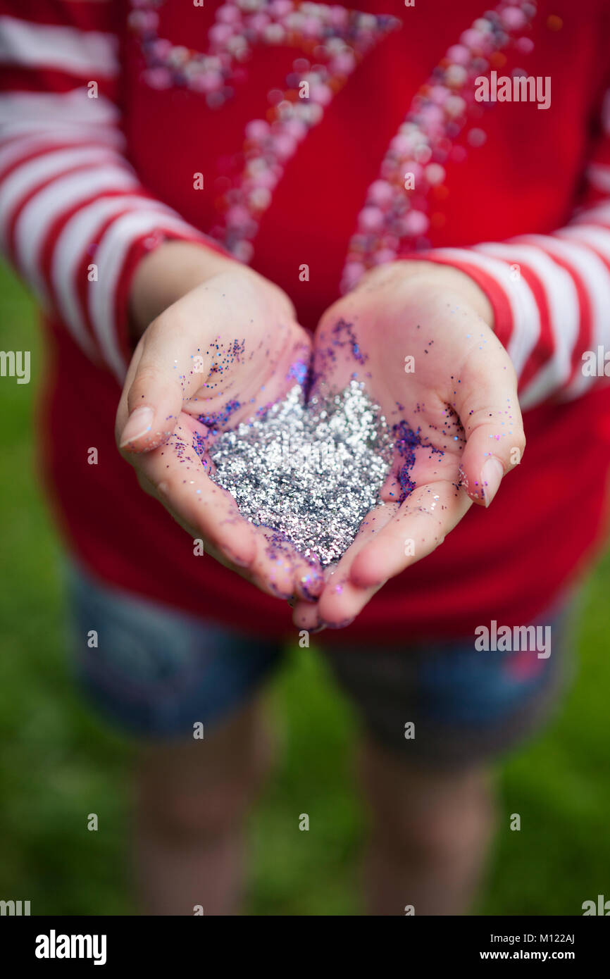 Child holding silver glitter in hands Stock Photo - Alamy