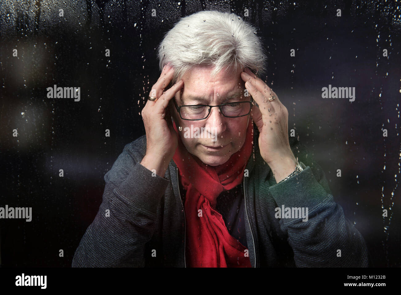 Stressed depressed man emotional portrait looking down hands on head at ...