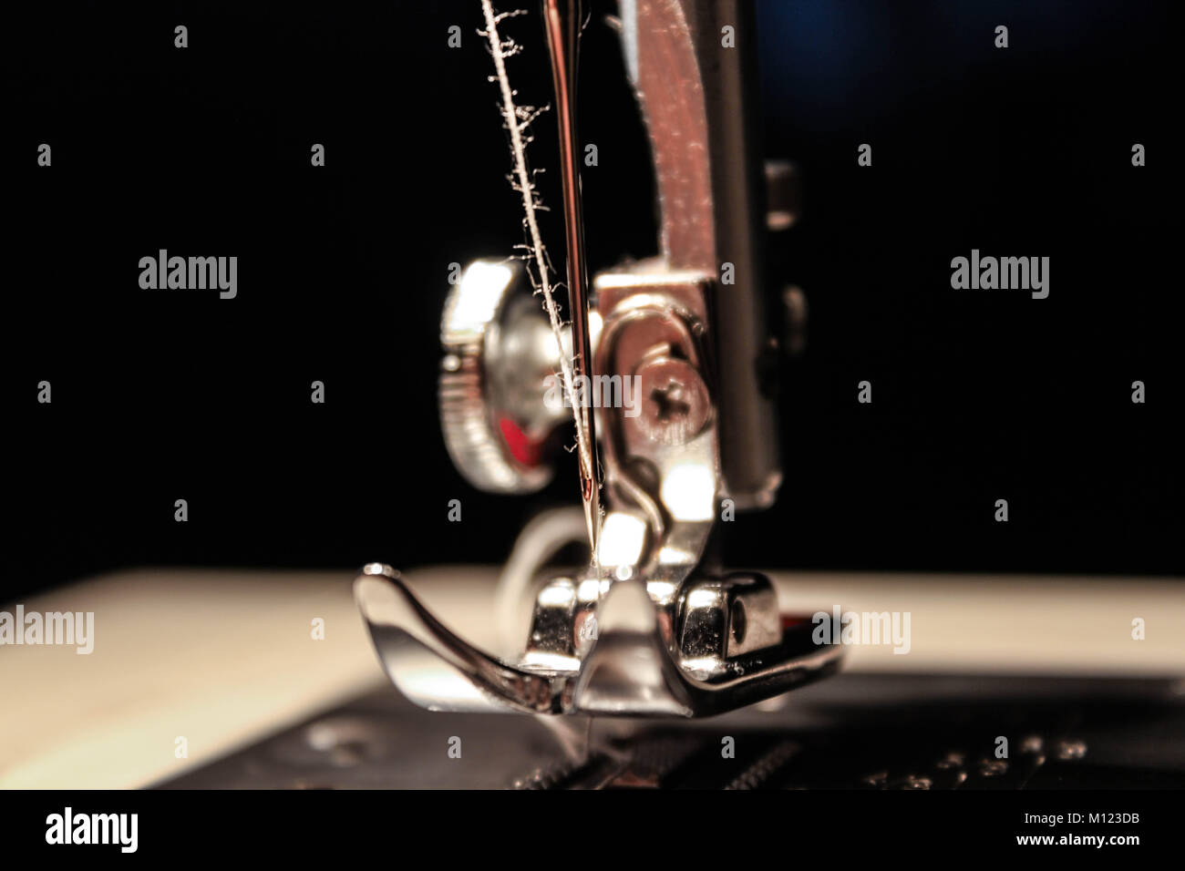 Sewing machine needle closeup Stock Photo - Alamy