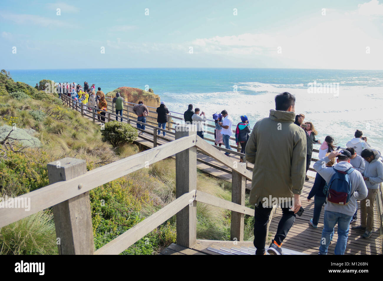 Tourists exploring scenic coastal lookout along the Great Ocean Road ...