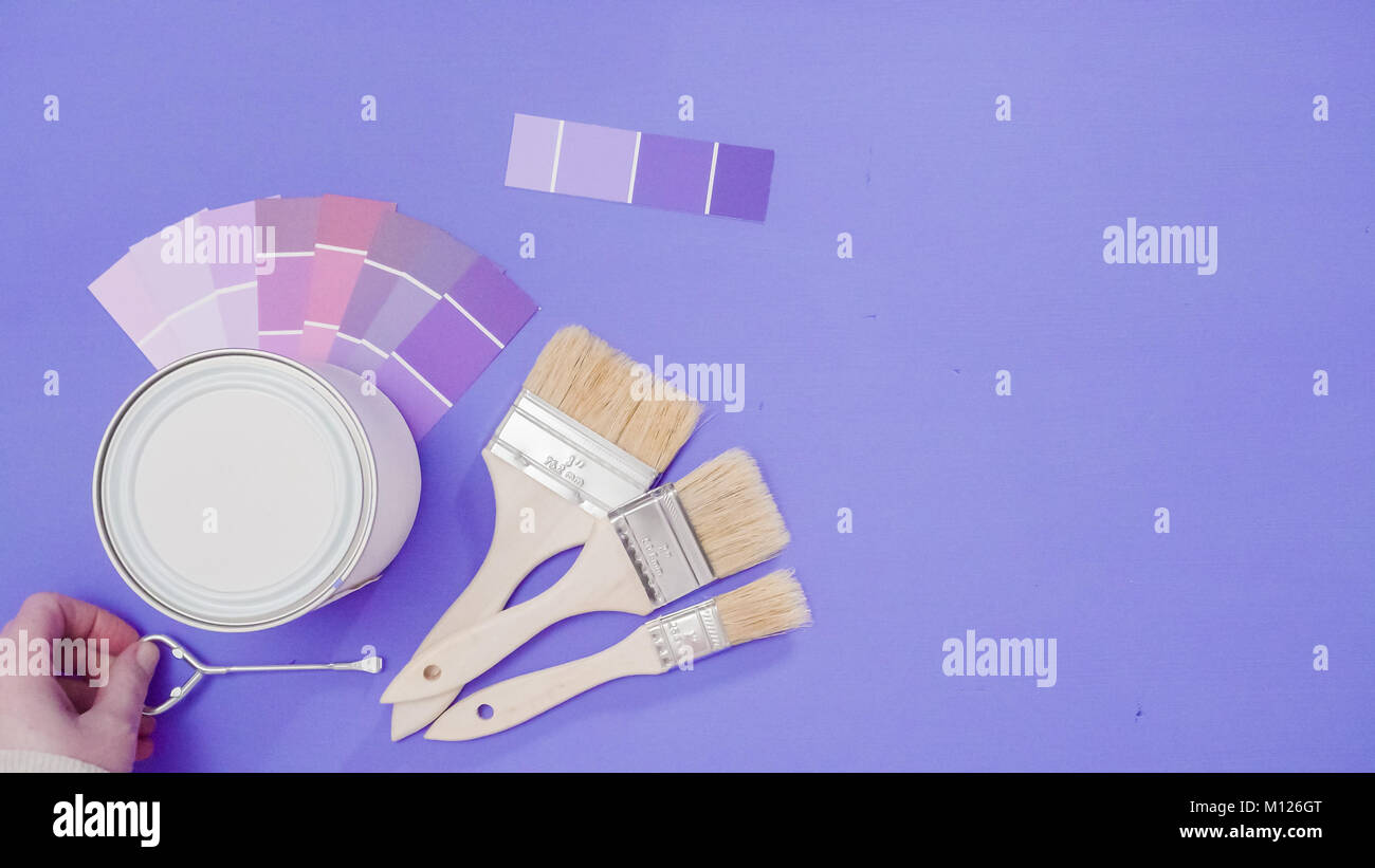 Metal paint can with purple paint and other paint tools for home ...