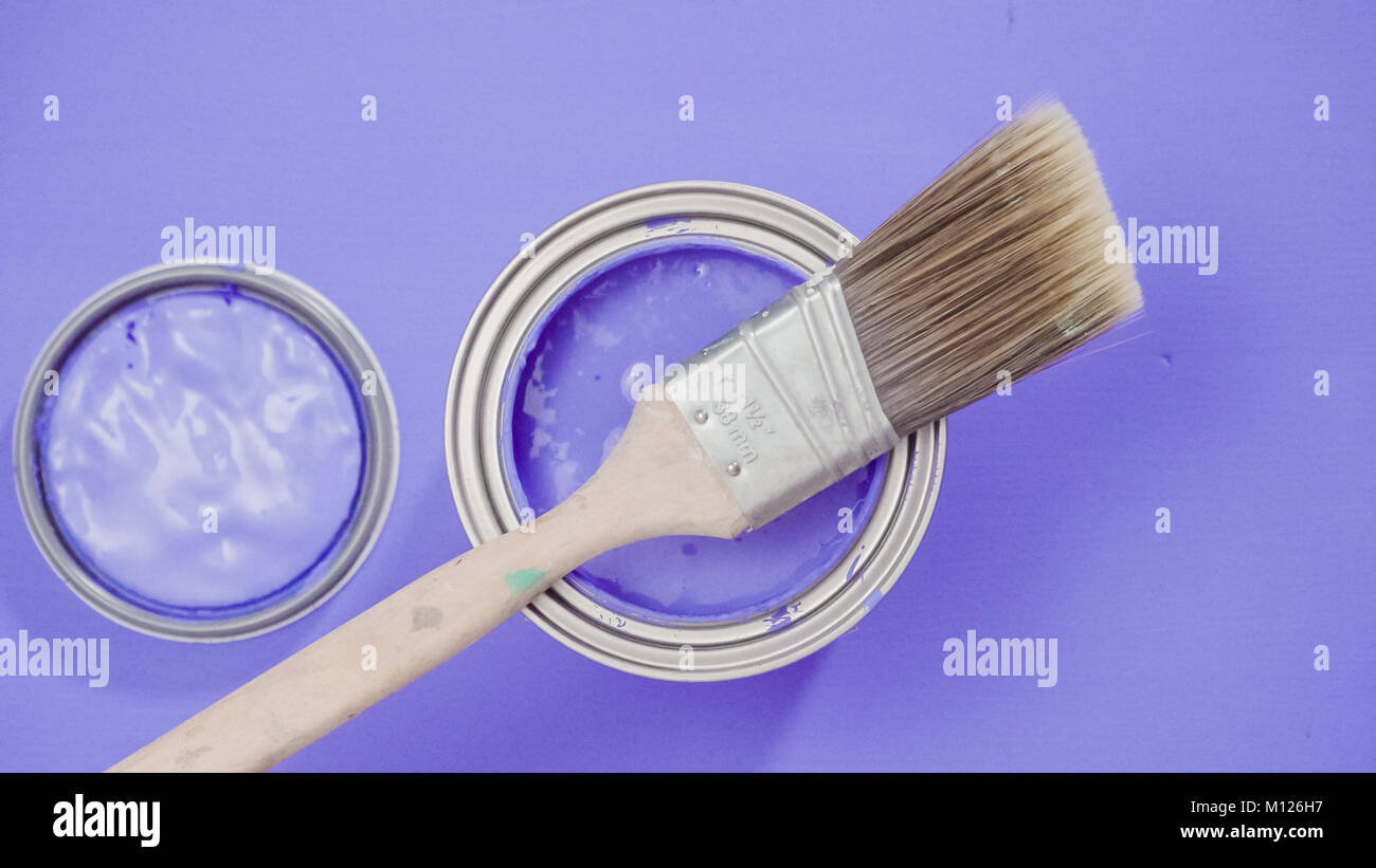 Metal paint can with violet paint and paint brush Stock Photo - Alamy