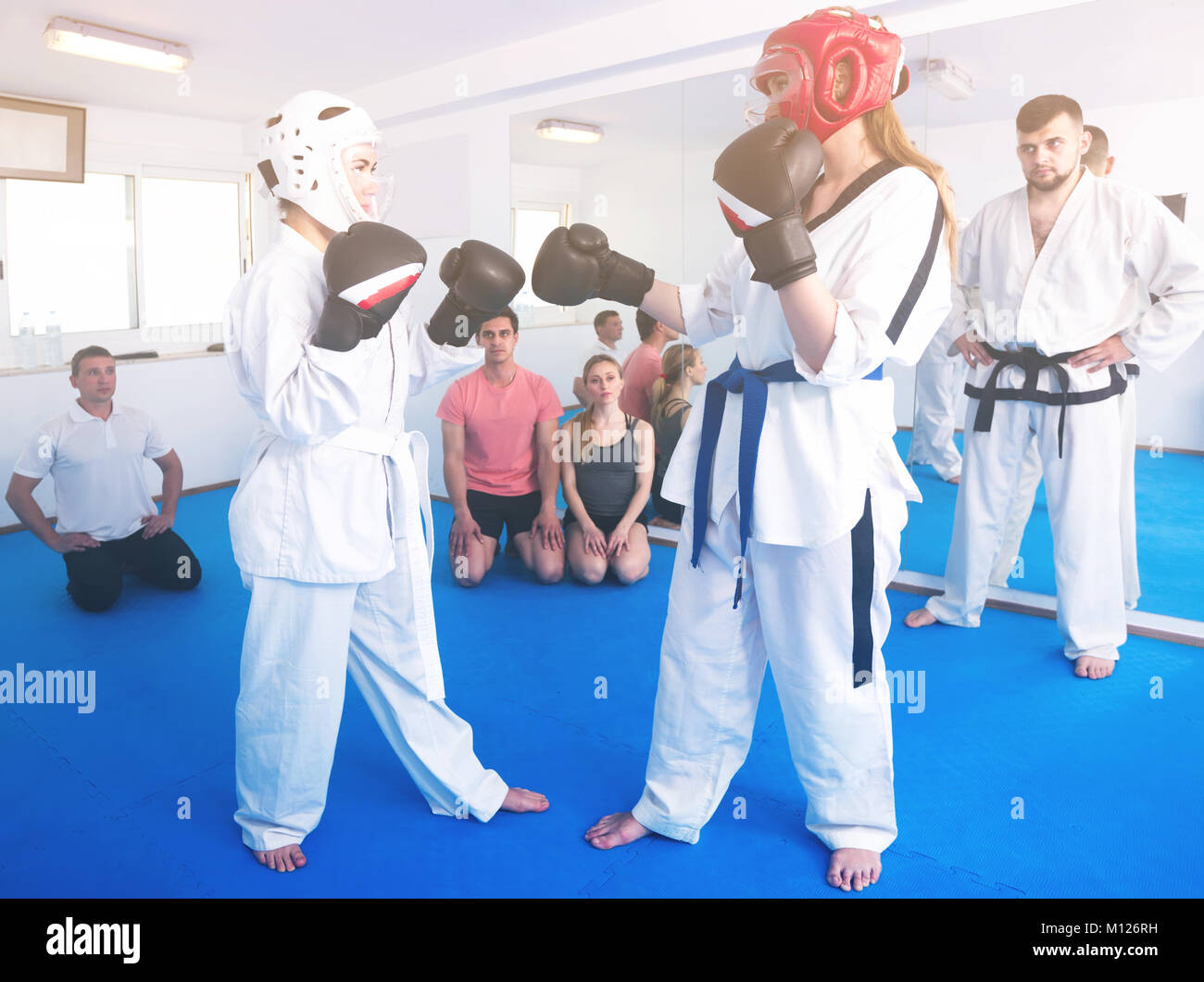 Female trainees conduct sparring for a taekwondo class Stock Photo - Alamy