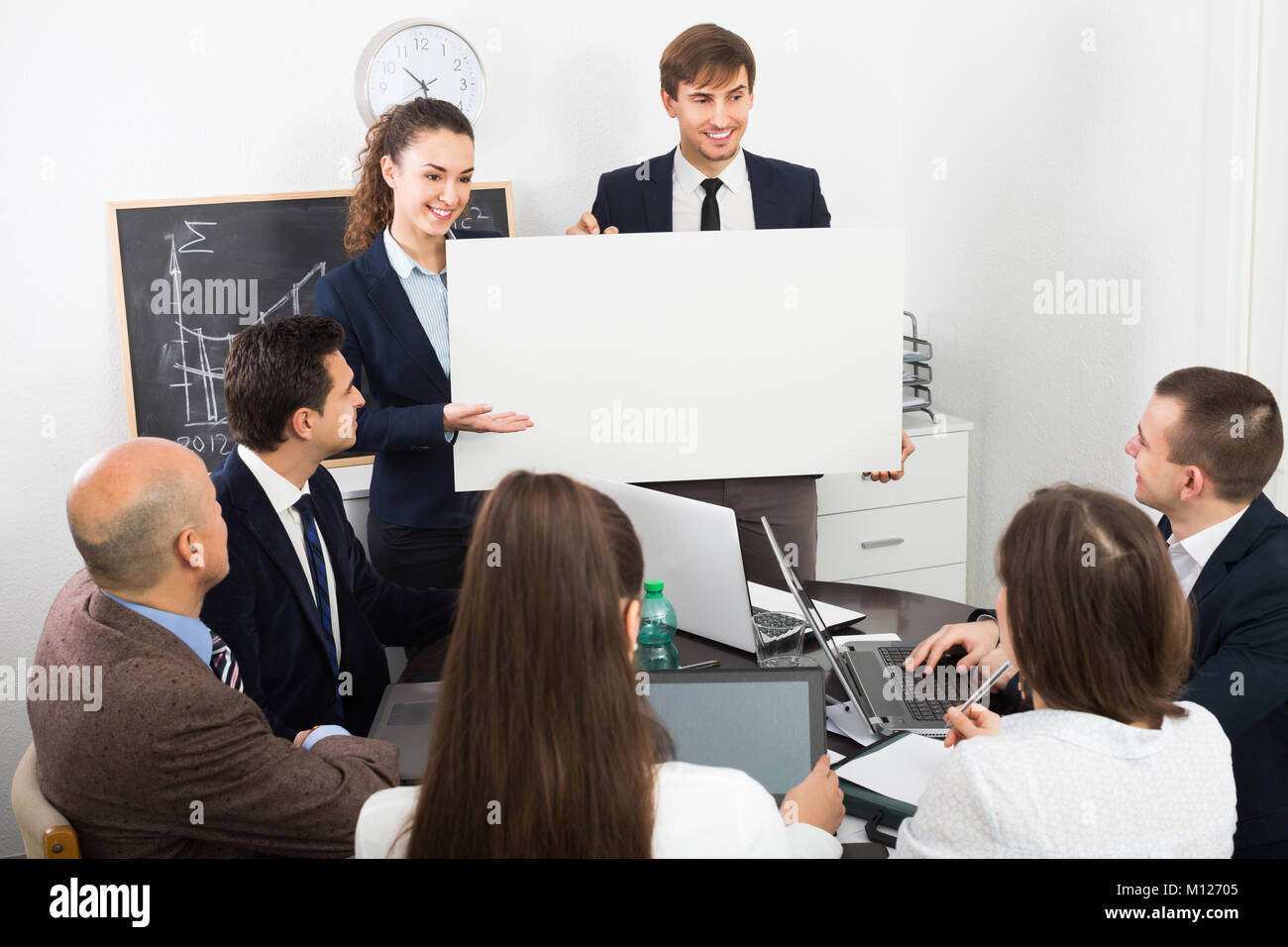 Presenting products, smiling hi-res stock photography and images - Alamy