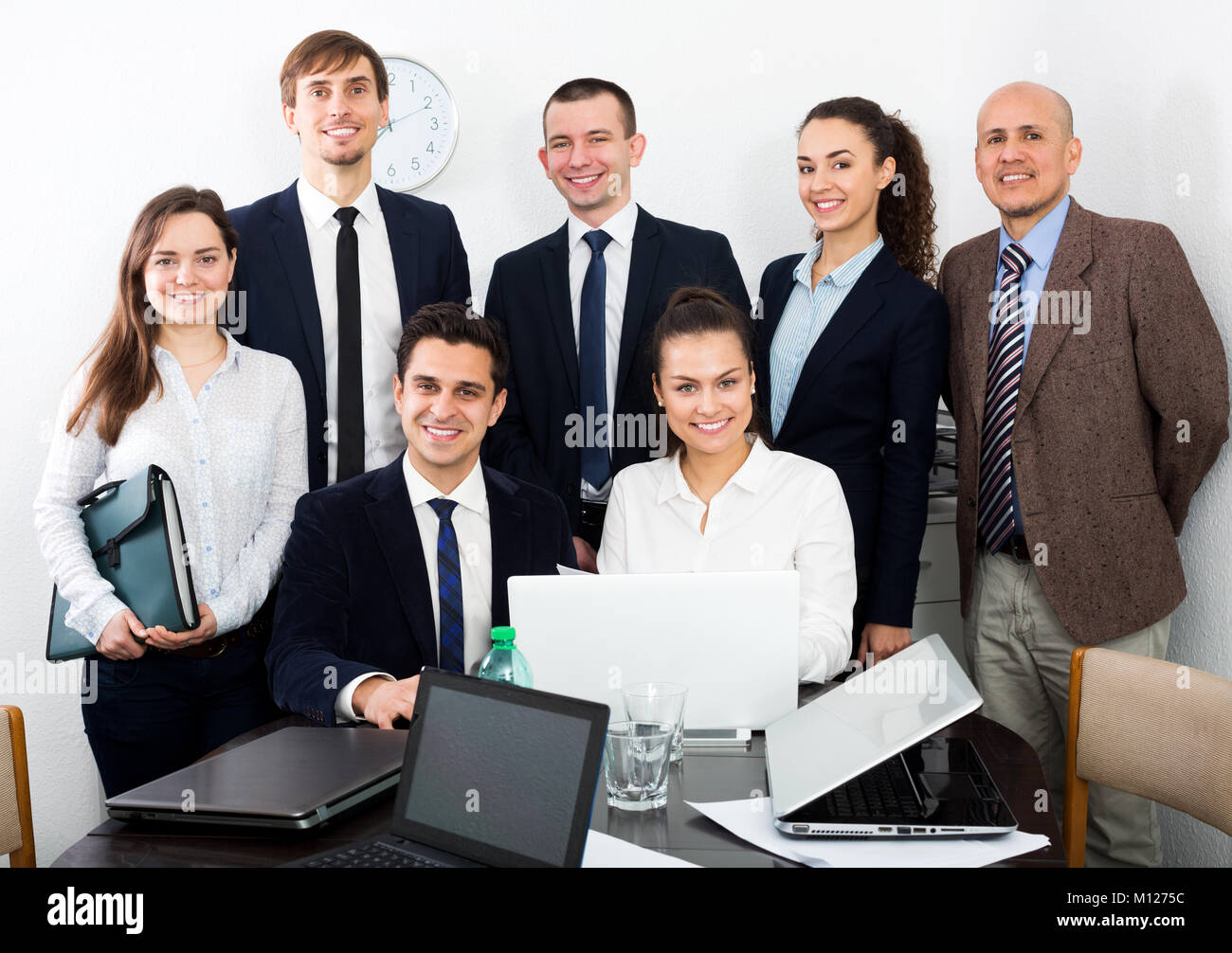 Portrait of happy business team smiling and posing in office Stock ...