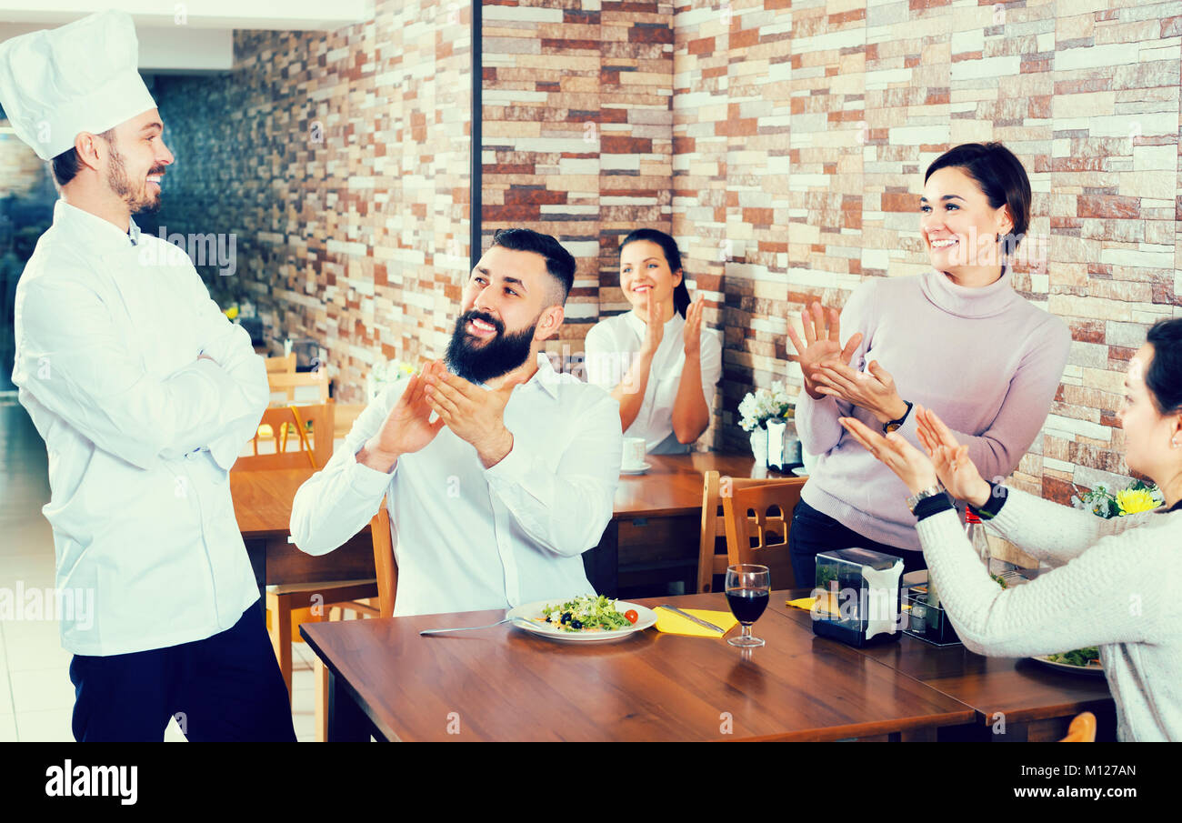 Happy chef listens to praise of the food in restaurant Stock Photo - Alamy