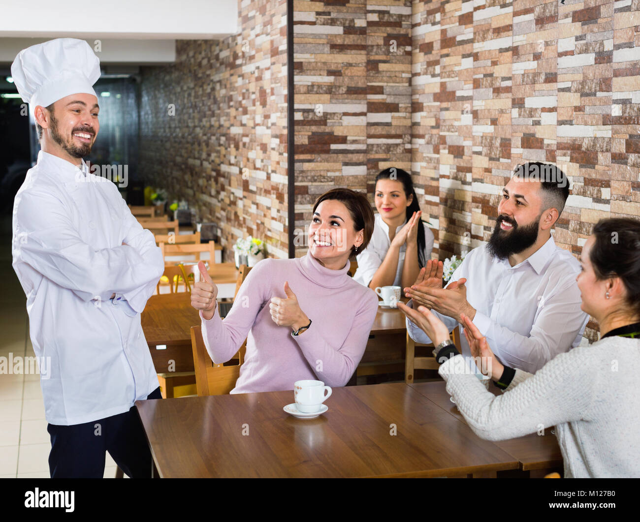 Glad smiling chef listens to praise of the food Stock Photo - Alamy