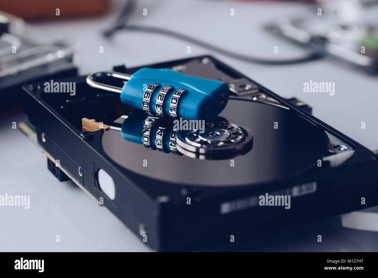 Encrypted hard disk. Padlock with cipher on an opened hard disk. Data ...