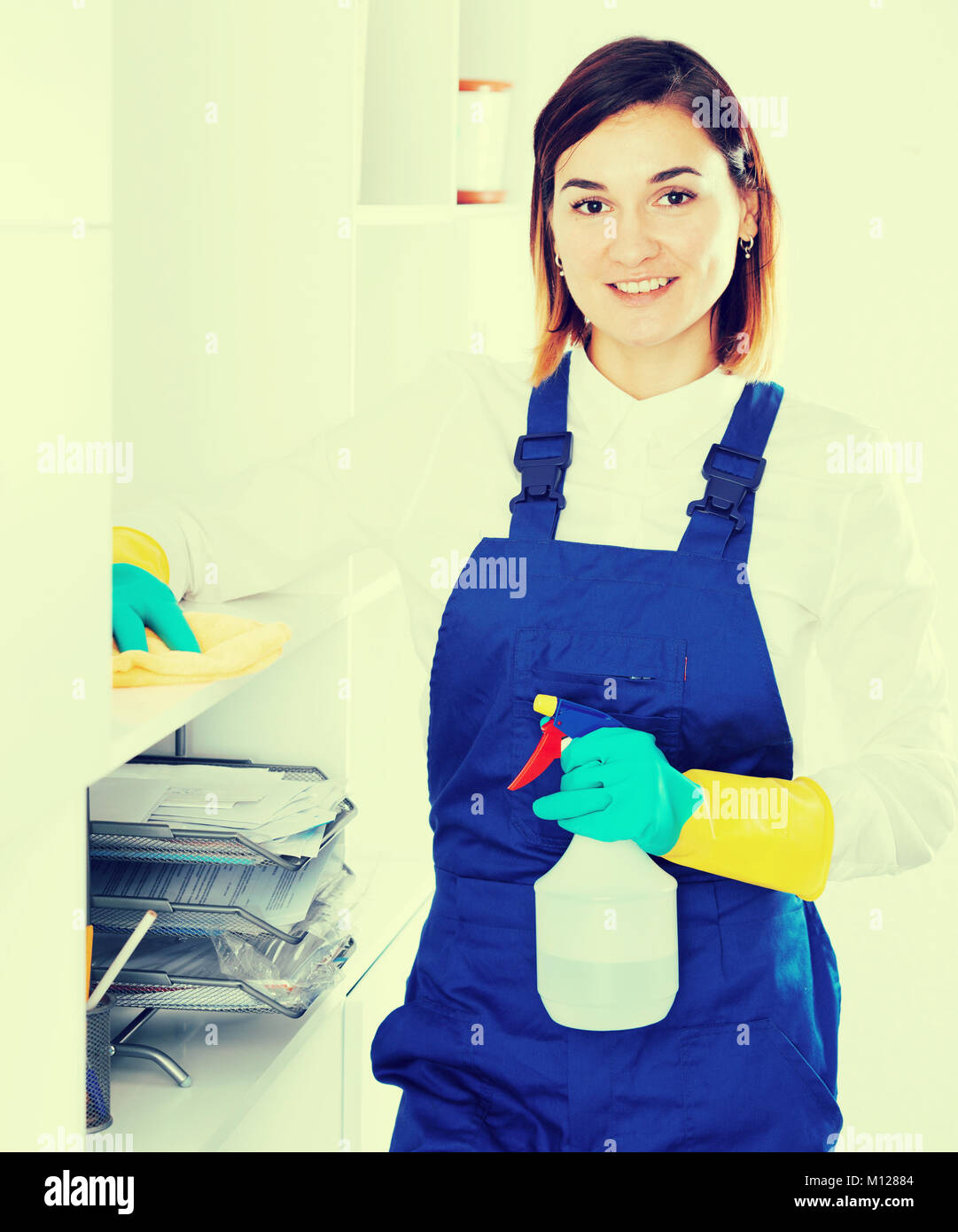 Smiling woman cleaner working effectively on task in office Stock Photo ...