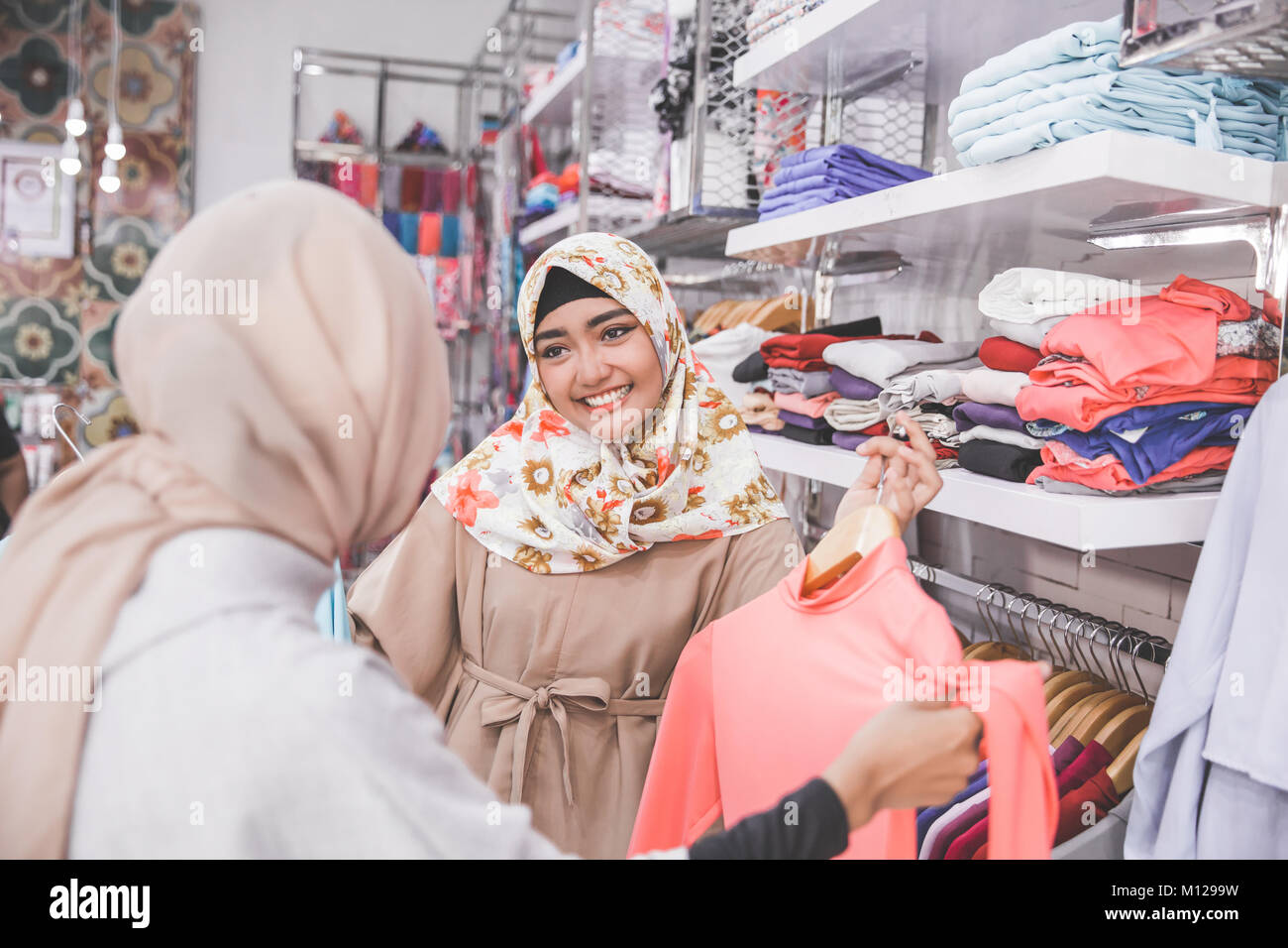 two happy female muslim best friend at fashion store Stock Photo - Alamy