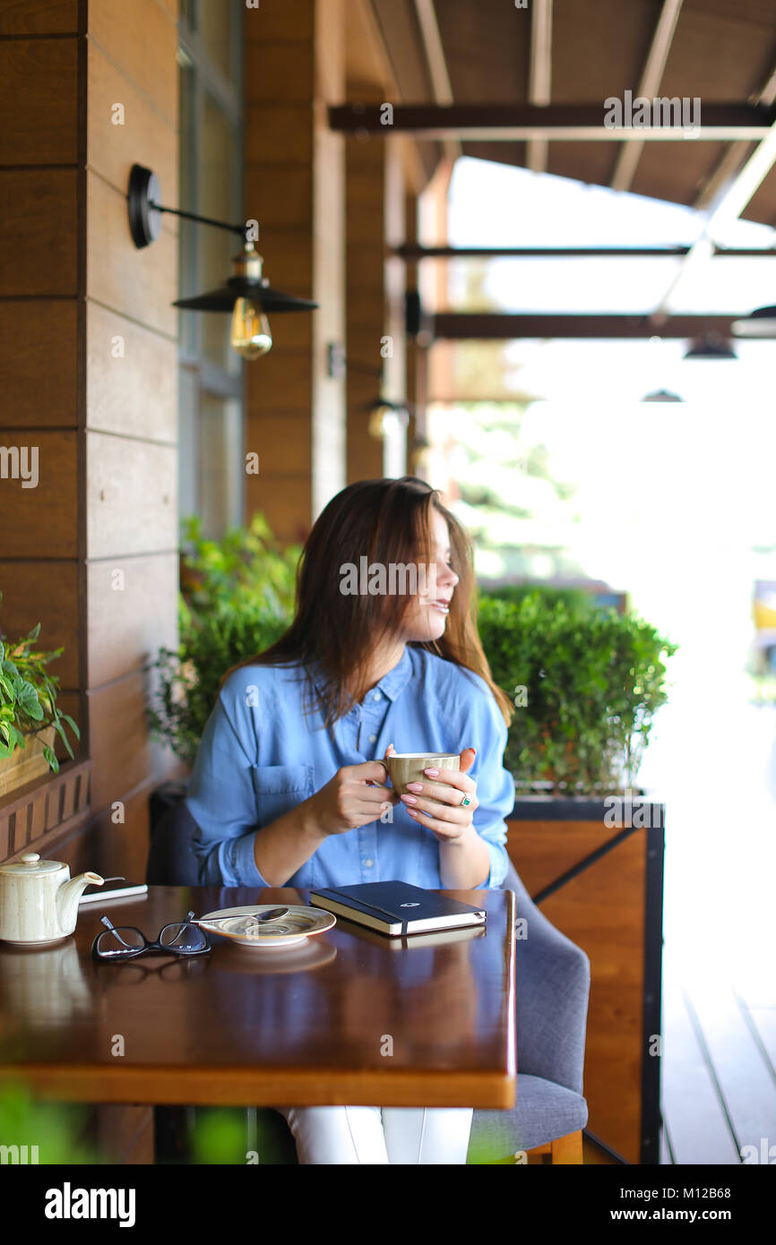 Charming girl drinking tea at restaurant Stock Photo - Alamy