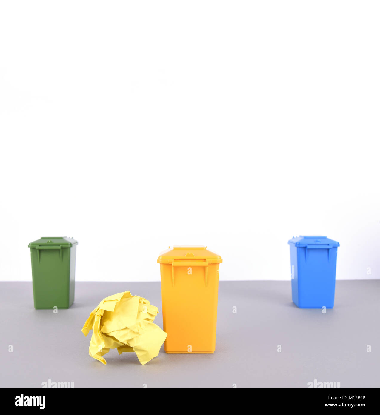 Colorful recycle bins on white background Stock Photo - Alamy