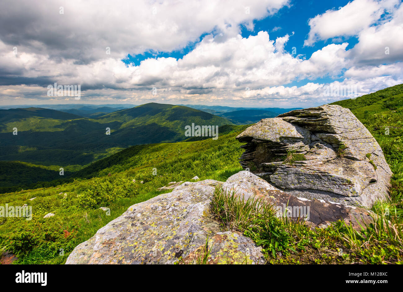 boulders on the grassy slope. rolling hills of Carpathian mountains in ...