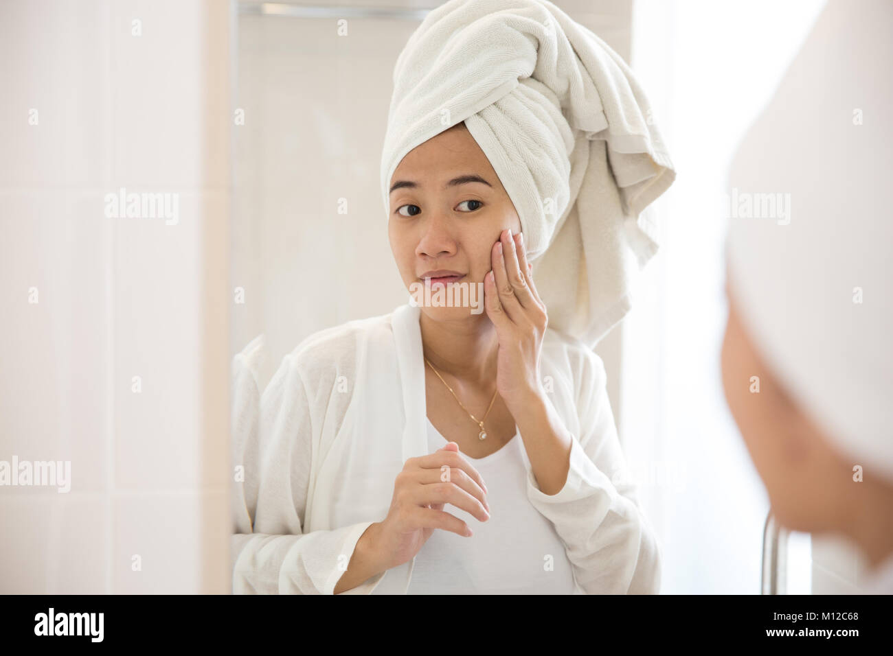 A portrait of an asian woman taking care her face Stock Photo - Alamy