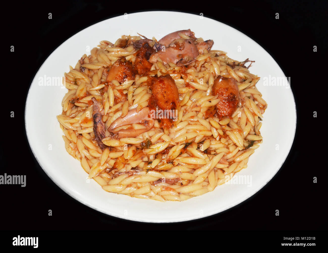 plate with cuttlefish and pasta - black background - mediterranean ...