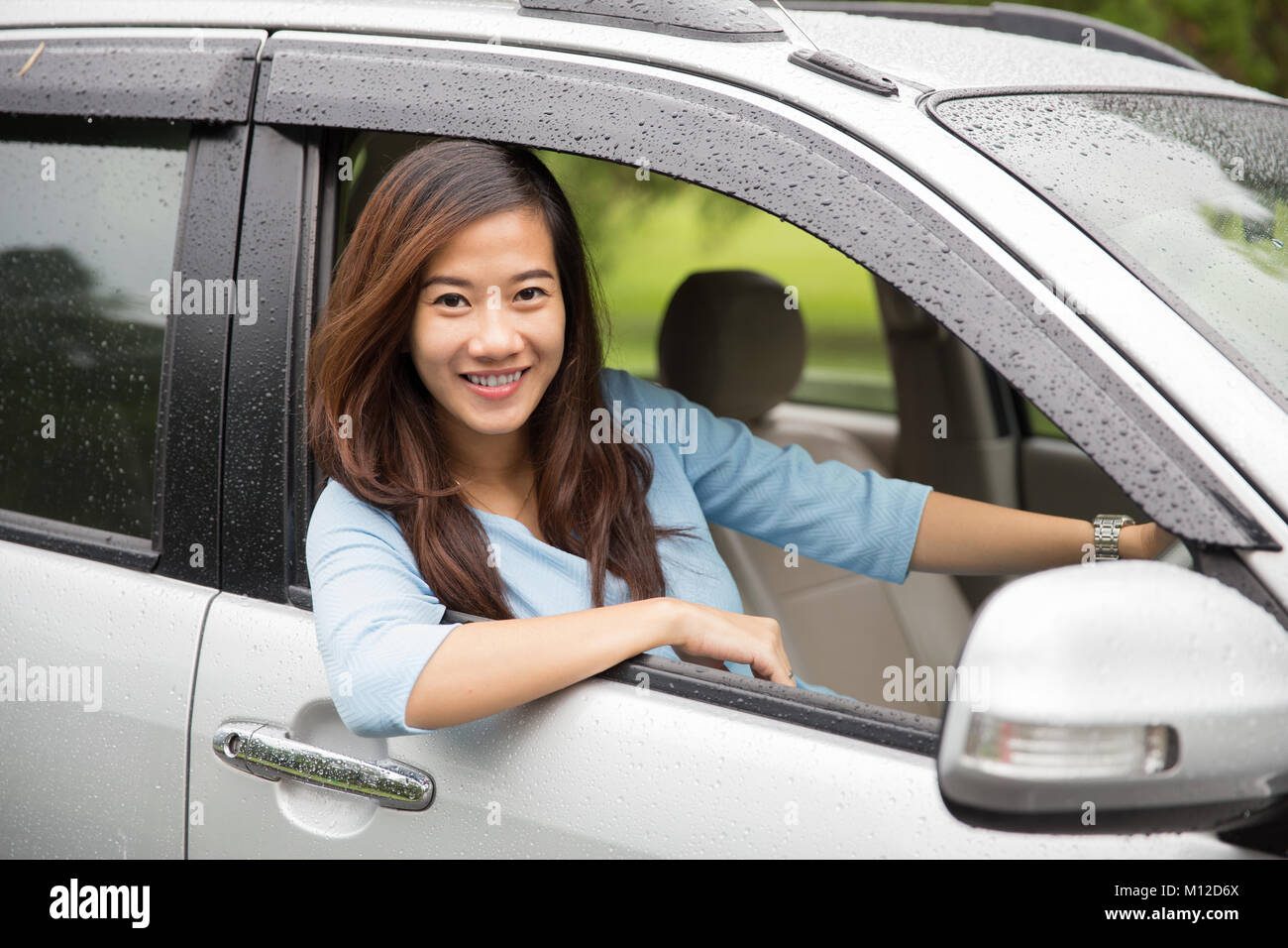 A portrait of a happy young asian woman riding a car Stock Photo - Alamy