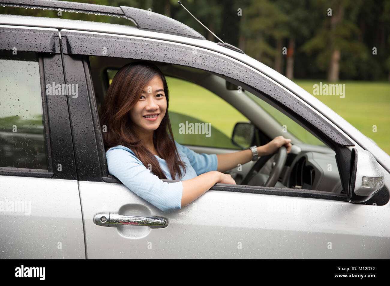 A portrait of a happy young asian woman riding a car Stock Photo - Alamy