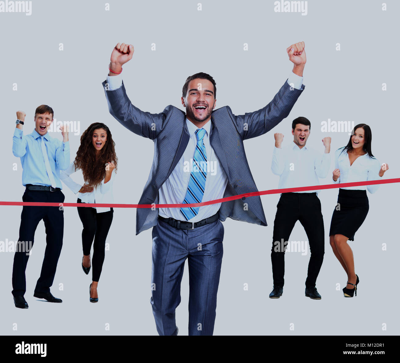 Happy businessman running through finishing line Stock Photo - Alamy