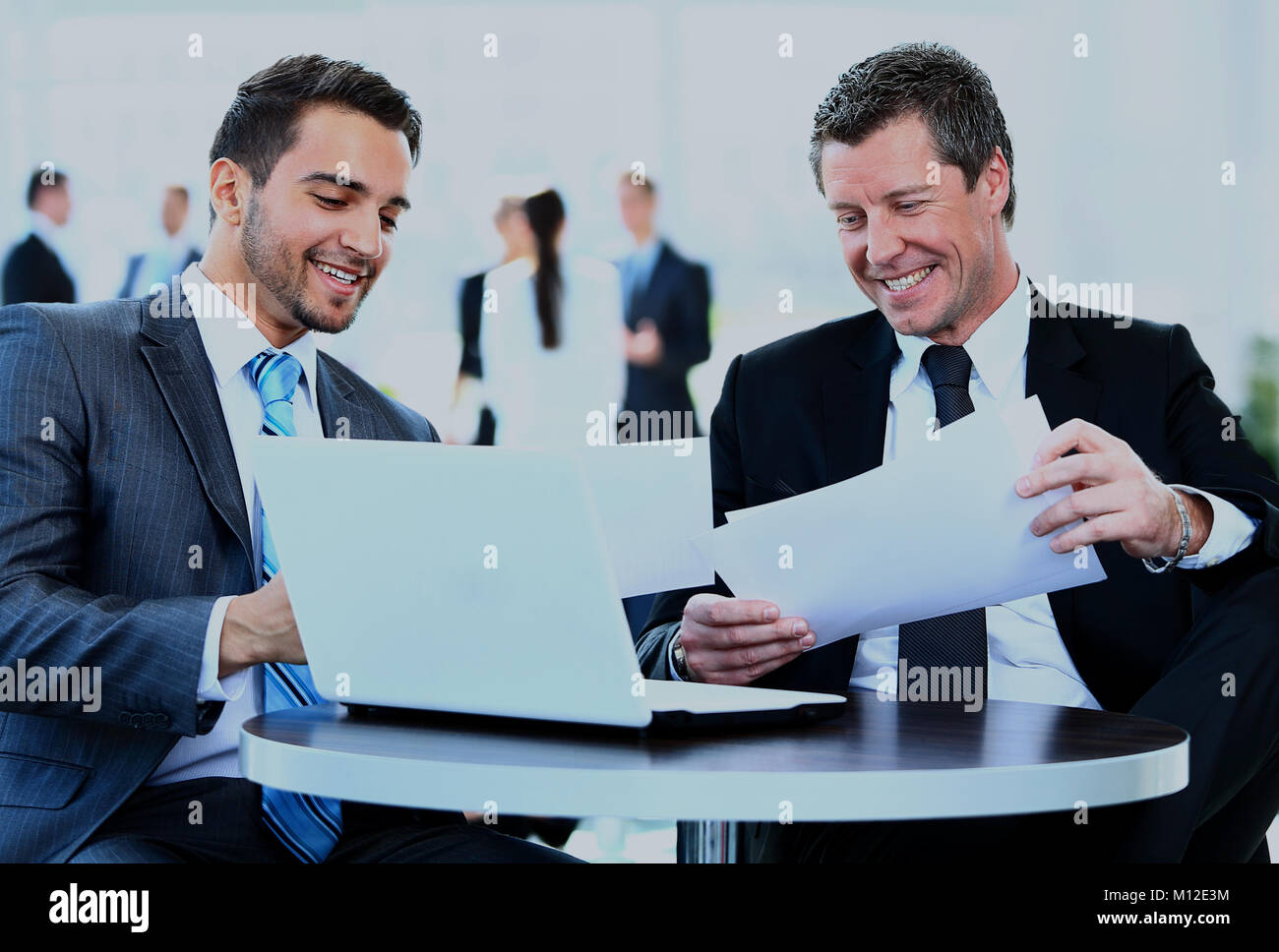 Business men discussing together in an office Stock Photo - Alamy