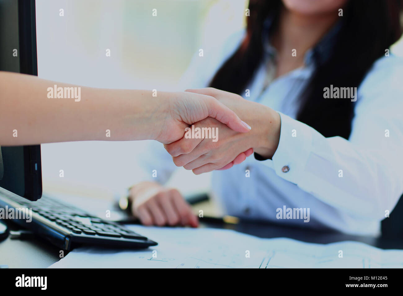 Close Up Of Two Women Shaking Hands, Indoors Stock Photo - Alamy
