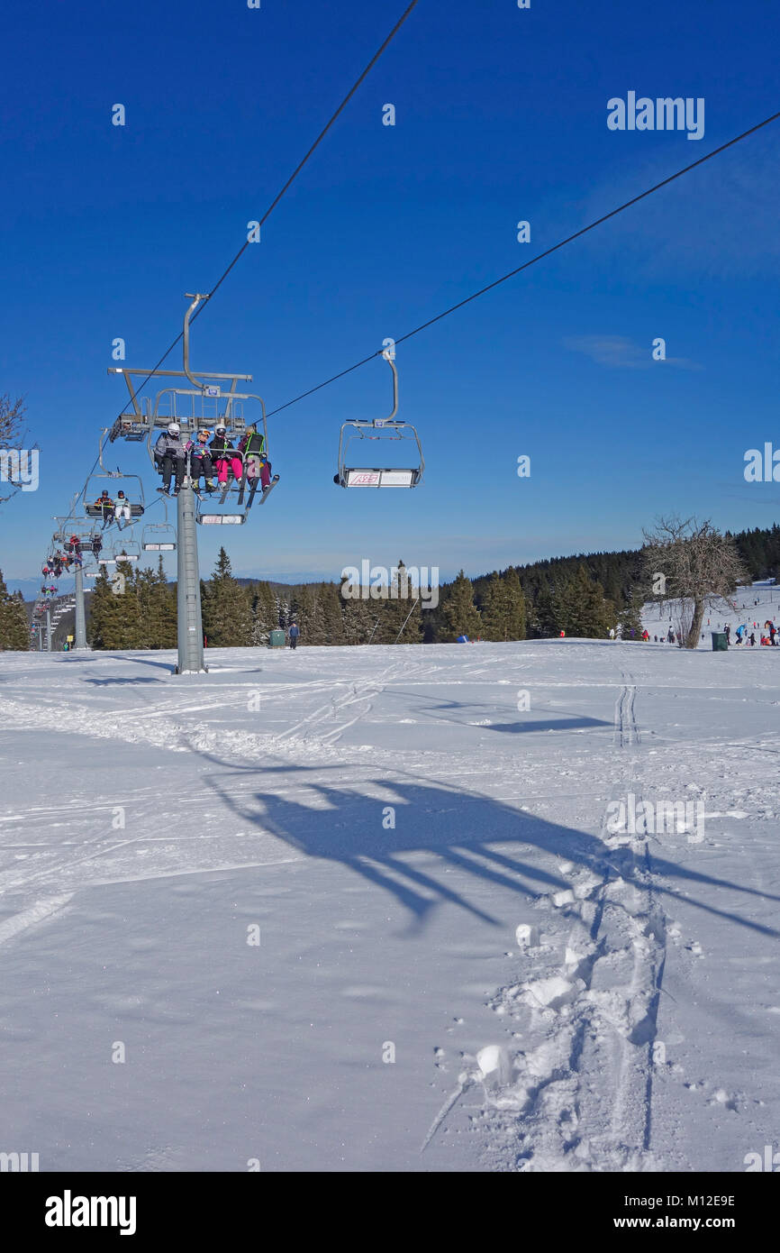 People riding the chair lift. Rogla ski resort, Pohorje, Slovenia Stock ...