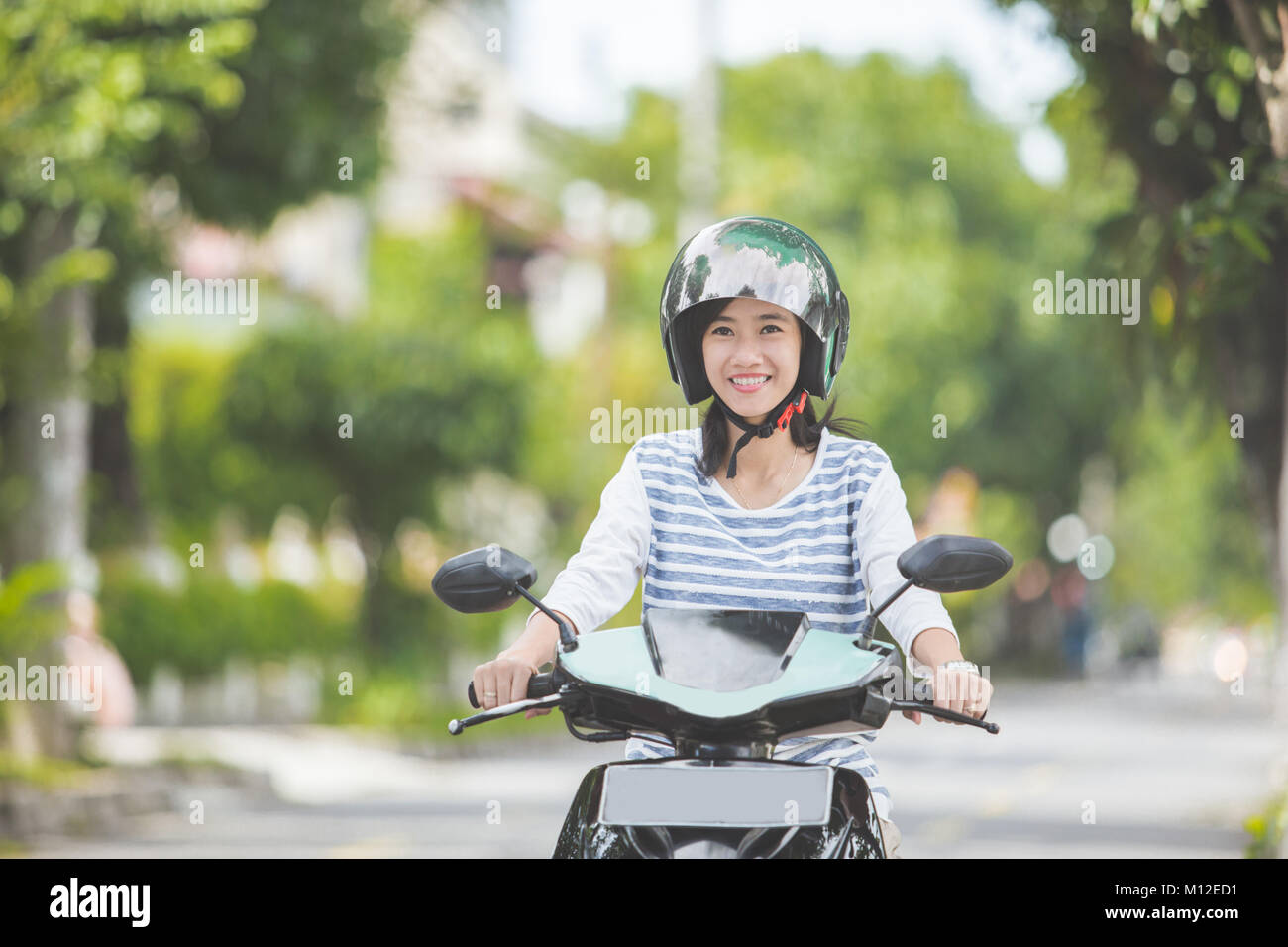 beautiful attractive asian woman riding motorcycle in the city street ...