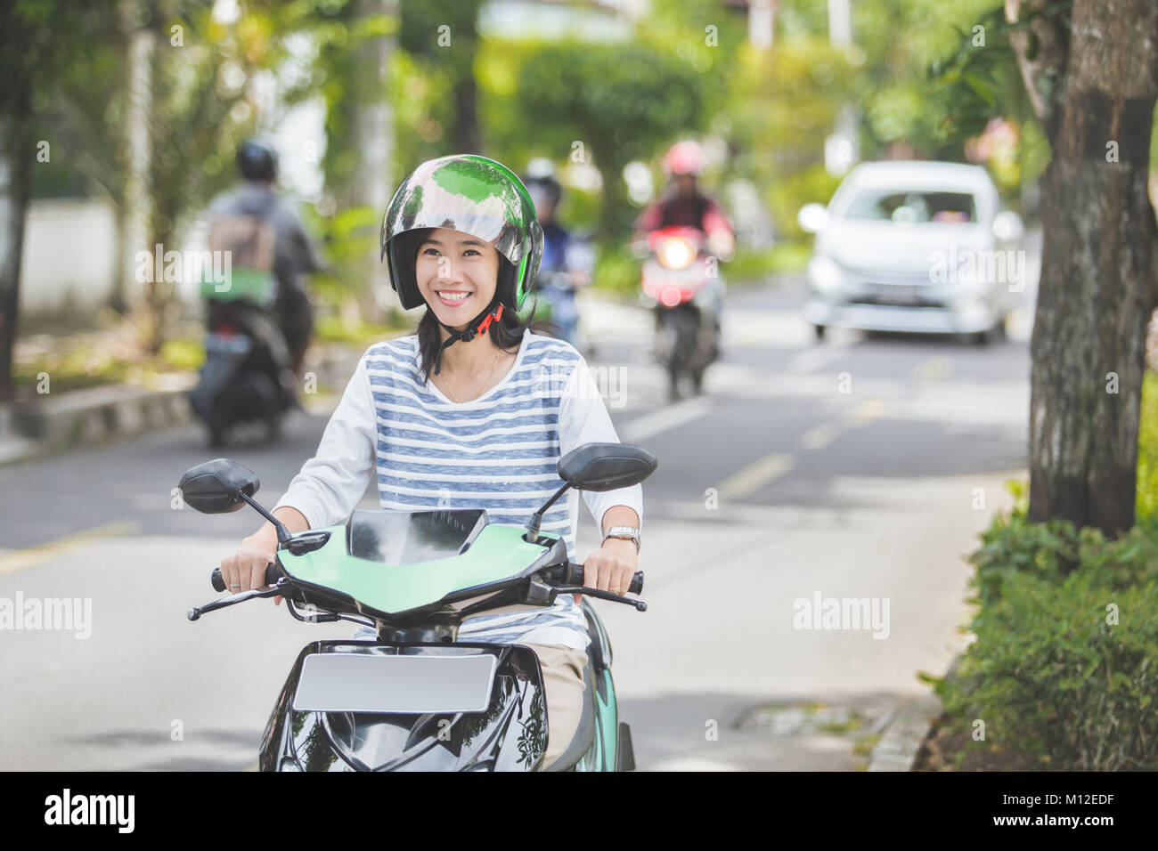 beautiful attractive asian woman riding motorcycle in the city street ...