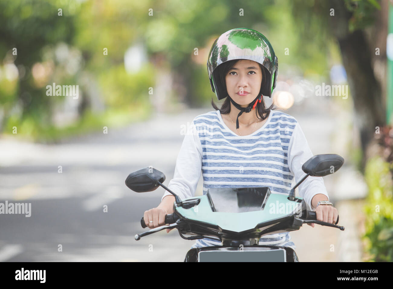 beautiful attractive asian woman riding motorcycle in the city street ...