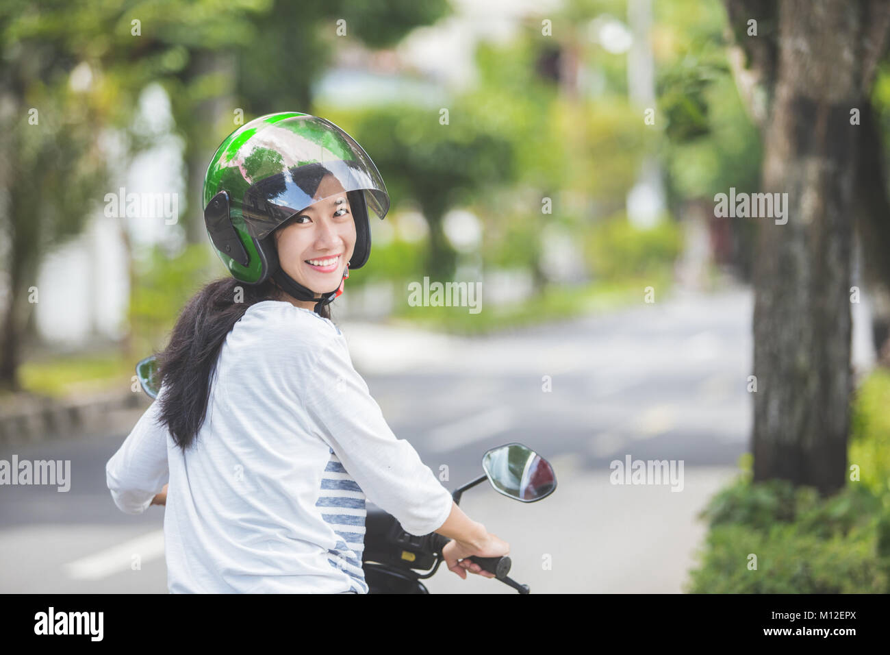 beautiful attractive asian woman riding motorcycle in the city street ...