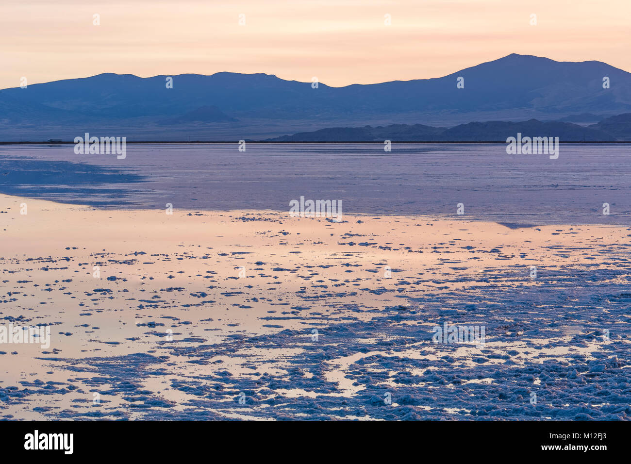 Salt crystals and briny water at twilight on the Bonneville Salt Flats ...