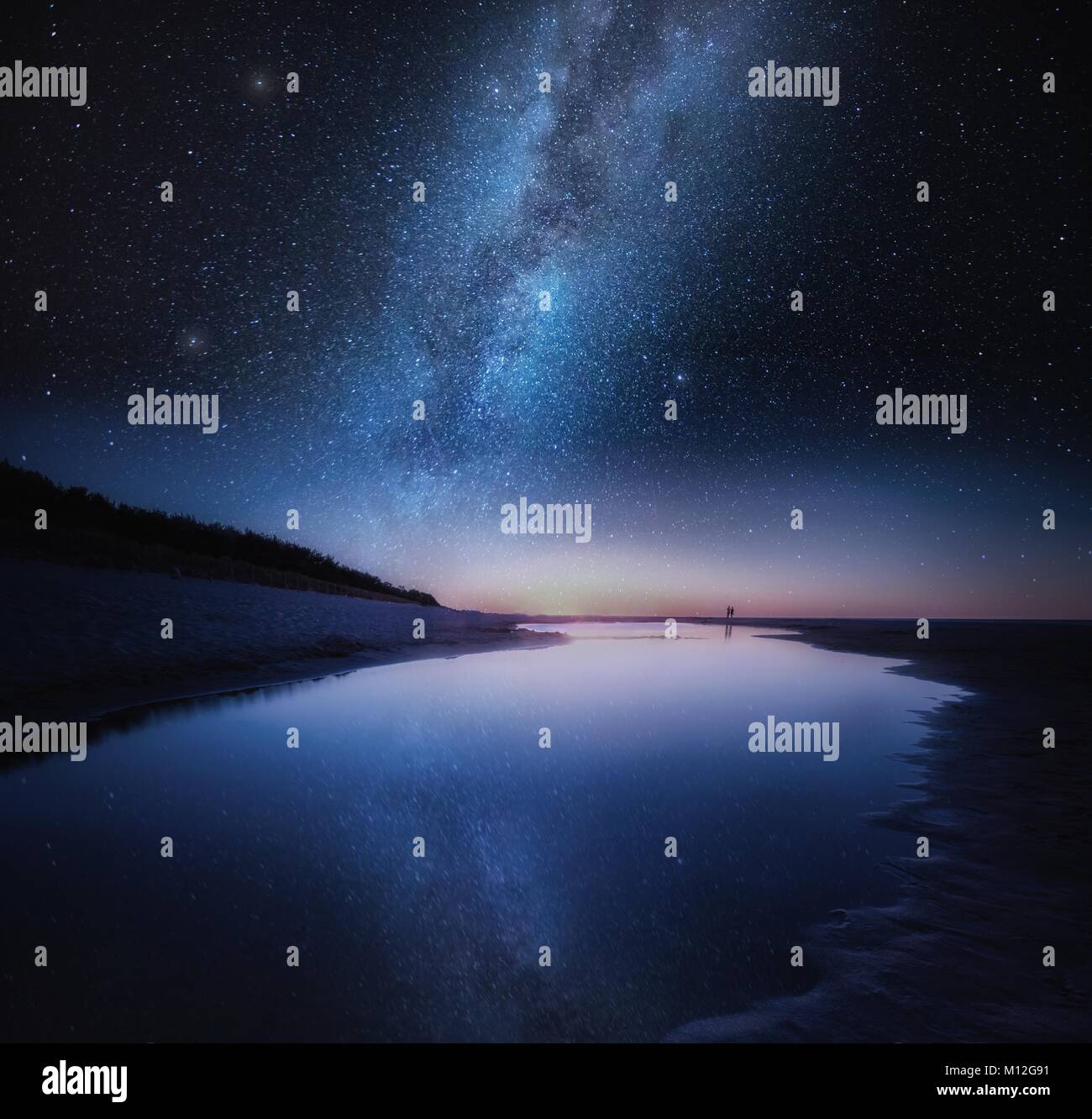 Sea shore in night with stars reflected in water. Fine art landscape ...