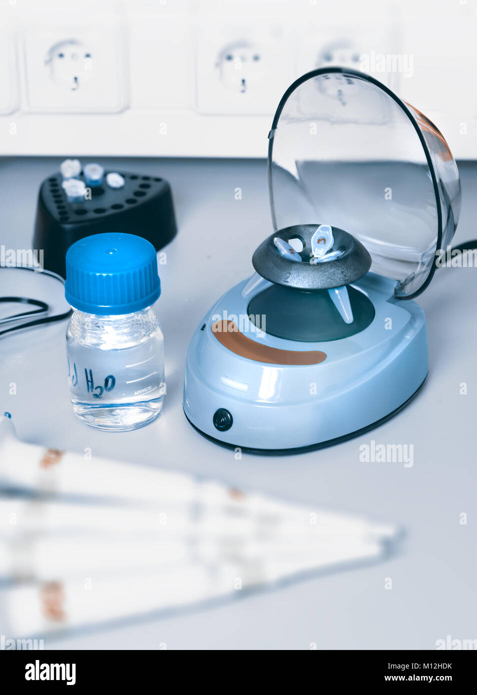 Small centrifuge and automatic pipettes in modern laboratory Stock ...