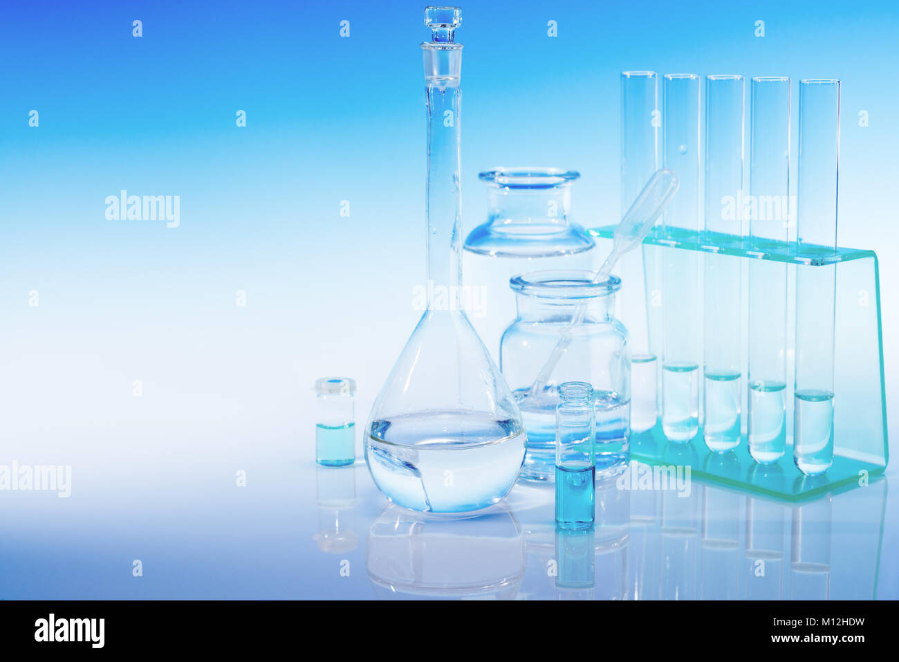 Scientific background with chemical glass, flask and tubes Stock Photo ...