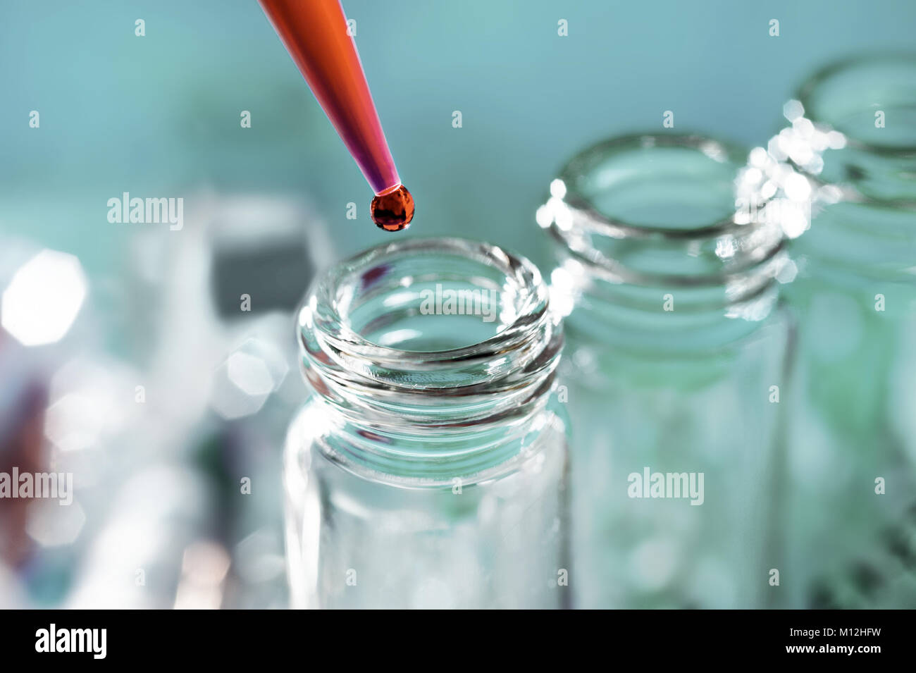 Closeup on pipette tip with red drop Stock Photo - Alamy