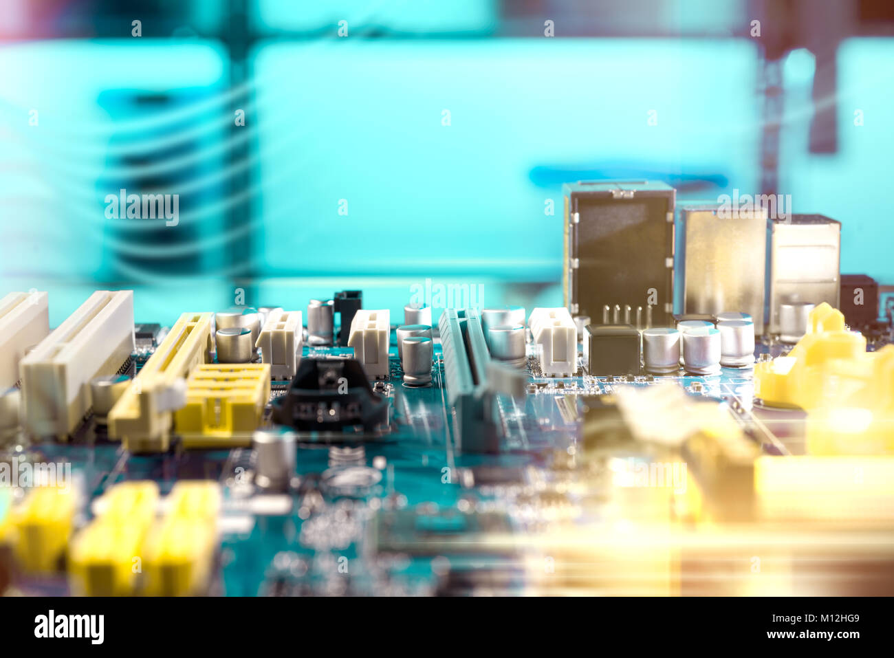 Closeup on electronic board in hardware repair shop, blurred and toned ...