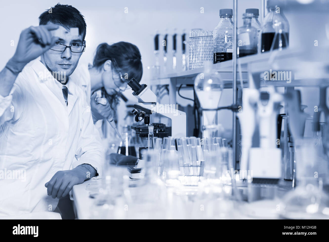 Health care researchers working in life science laboratory. Young ...