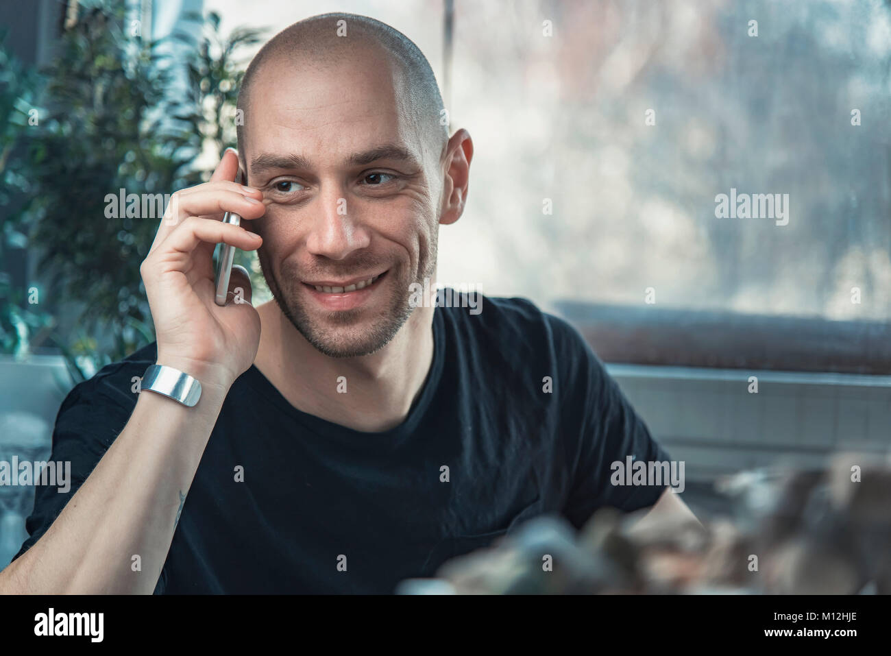 Young man having a cheerful phone call Stock Photo - Alamy