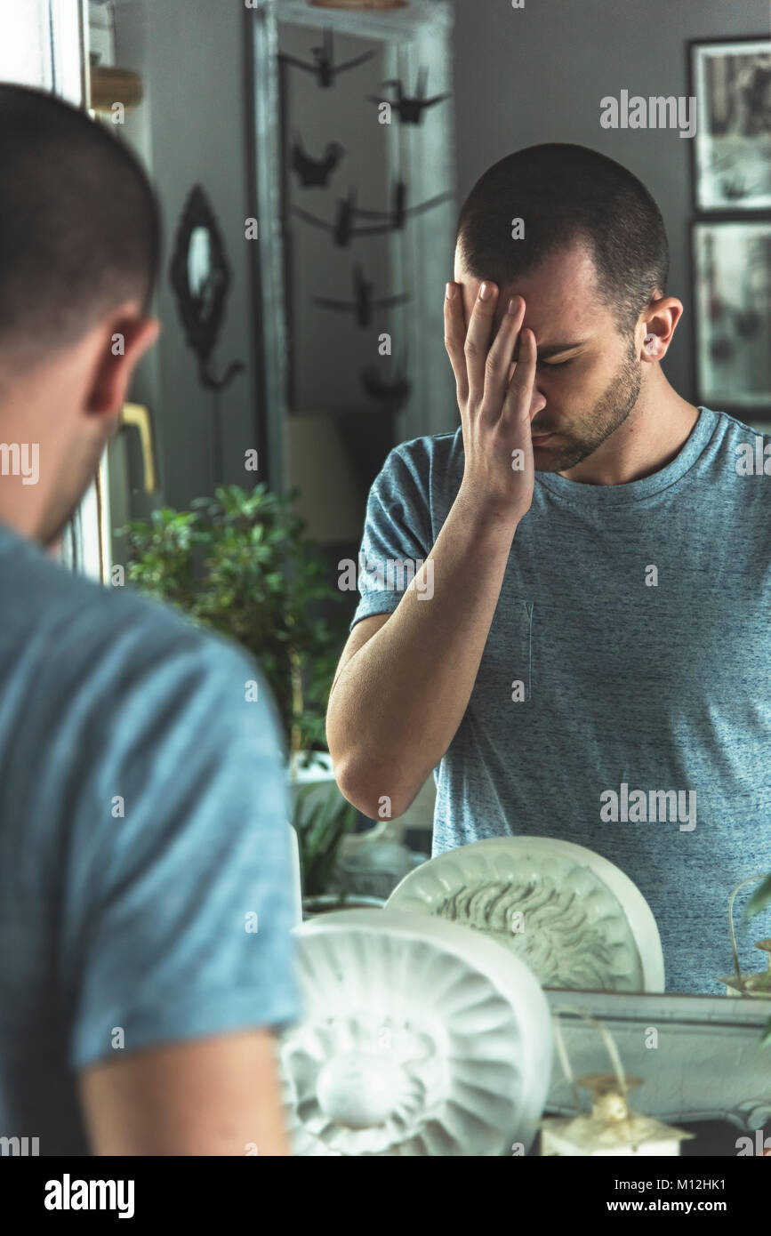 Young handsome man feeling depressed and sad Stock Photo - Alamy