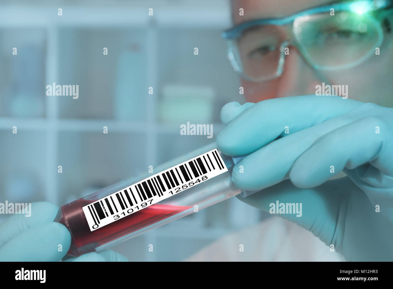 Tech with a medical sample labeled with a barcode Stock Photo - Alamy